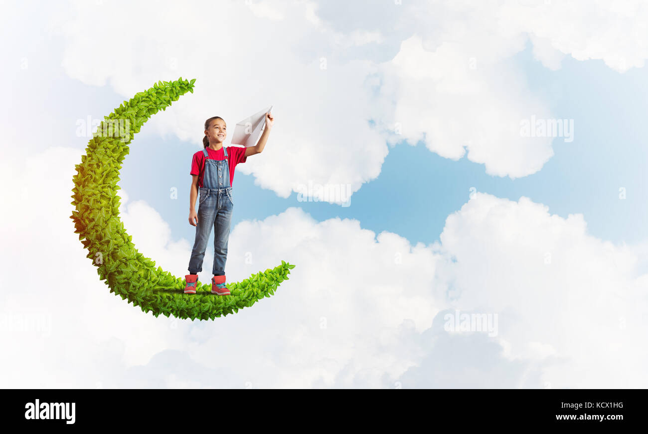 Concept of careless happy childhood with girl on green moon Stock Photo ...