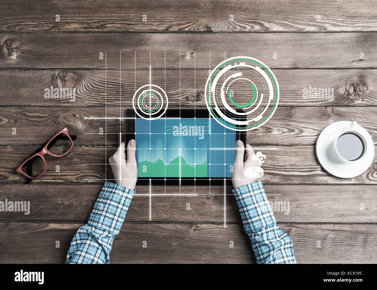 Business workplace with tablet device coffee cup and media graphs and ...