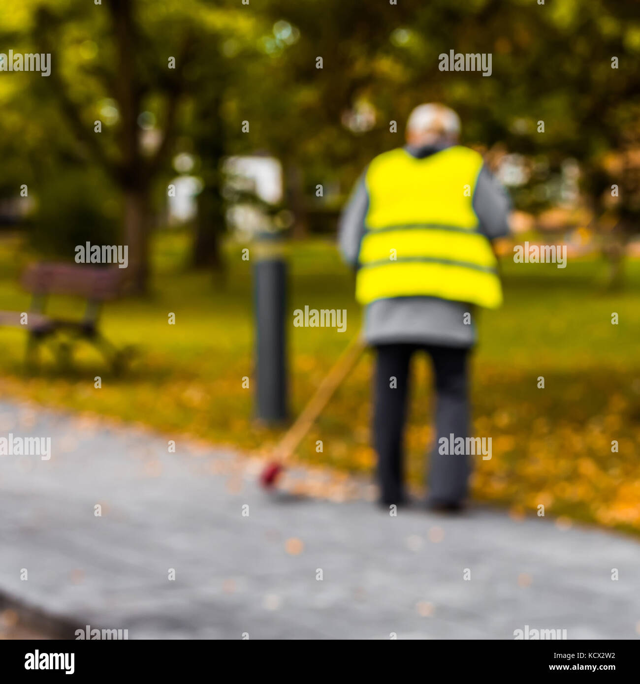 Abstract blurred background - road sweeper worker cleaning city street ...