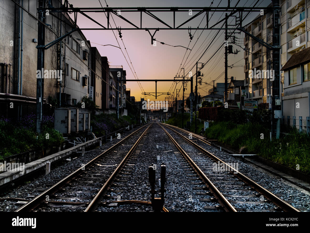 Train tracks fading into the distant sunset in Tokyo, Japan Stock Photo ...