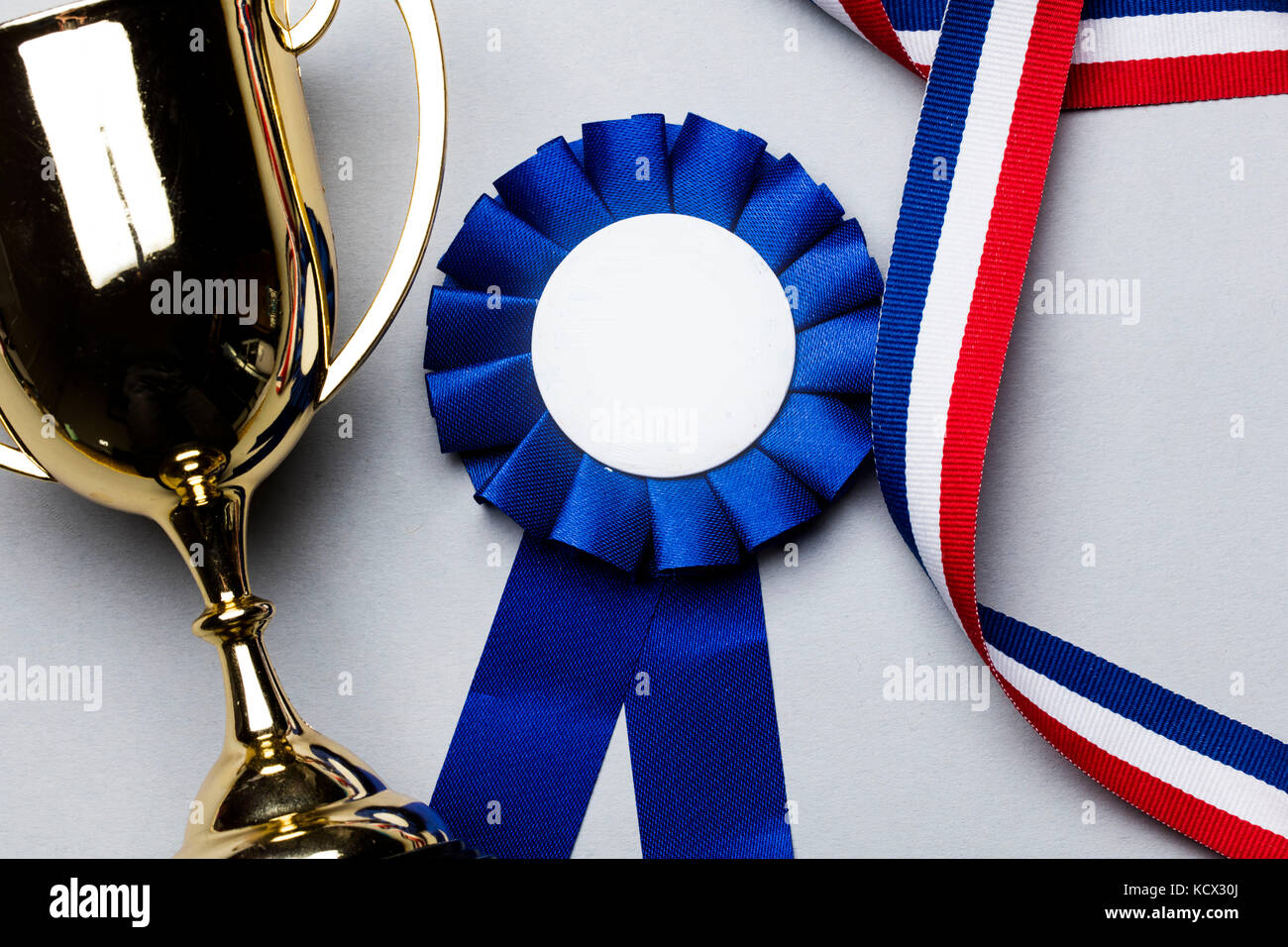 First place trophy and award rosette. Success achievement concept Stock ...