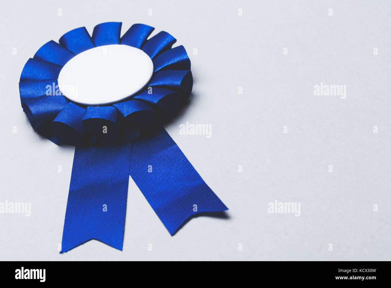 First place award rosette with blank white centre. Success achievement ...