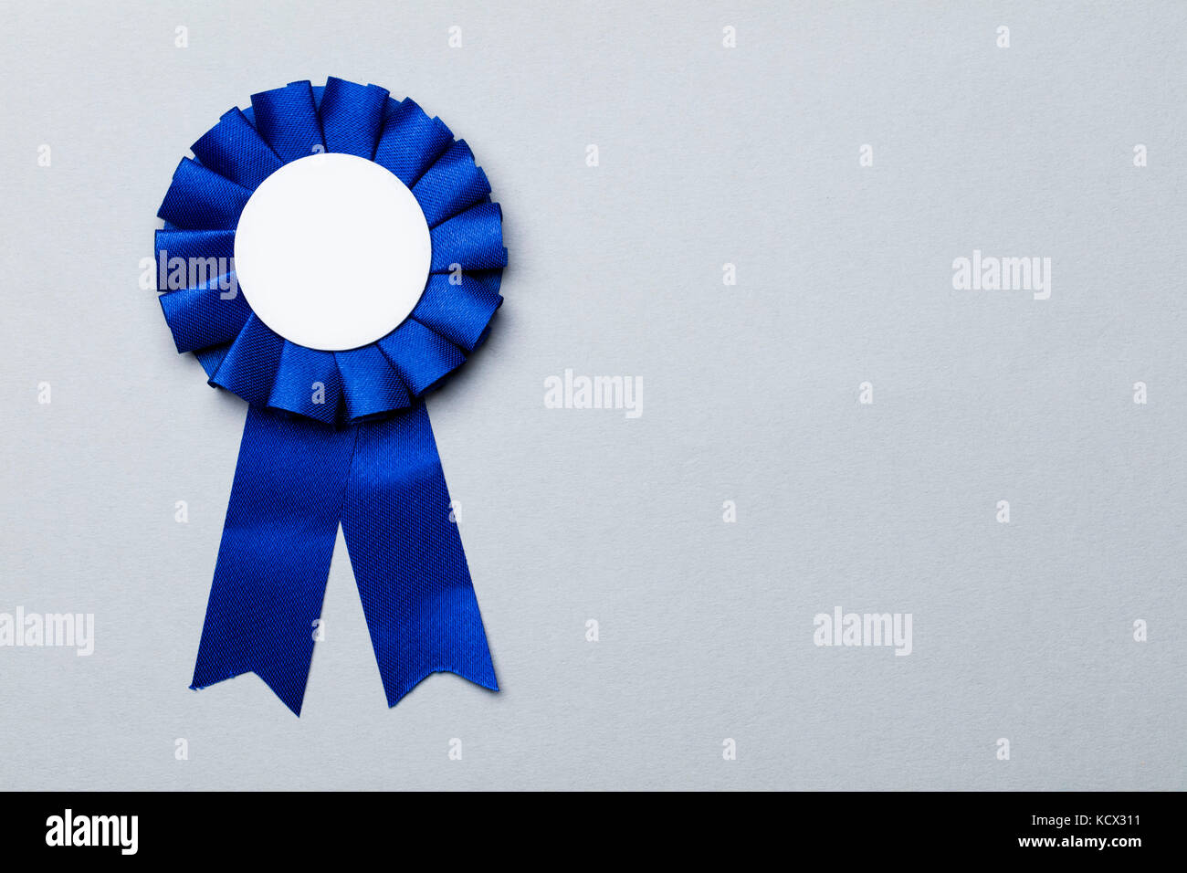 First place award rosette with blank white centre. Success achievement ...