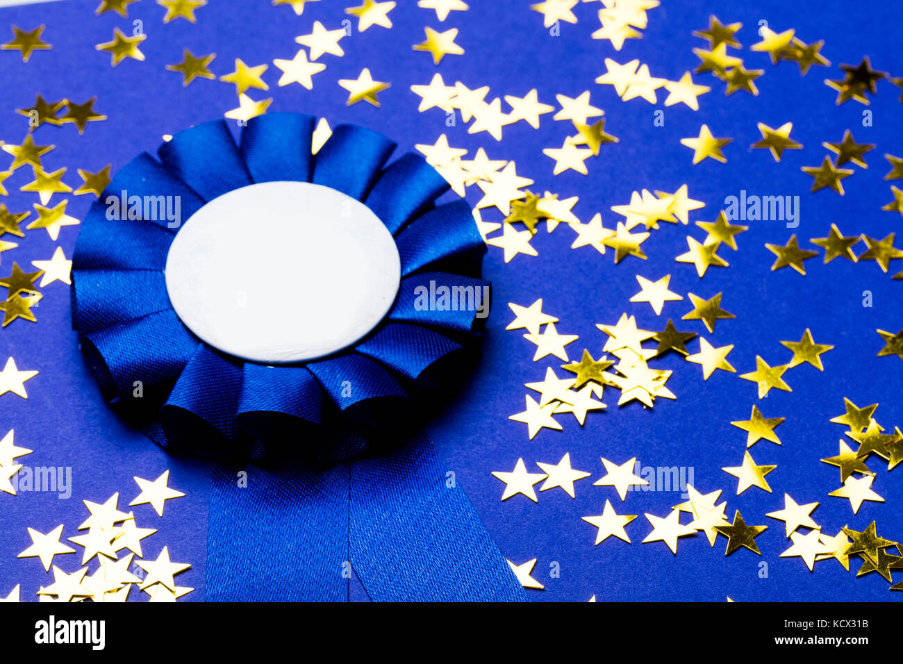 First place award rosette with gold stars. Success achievement concept ...