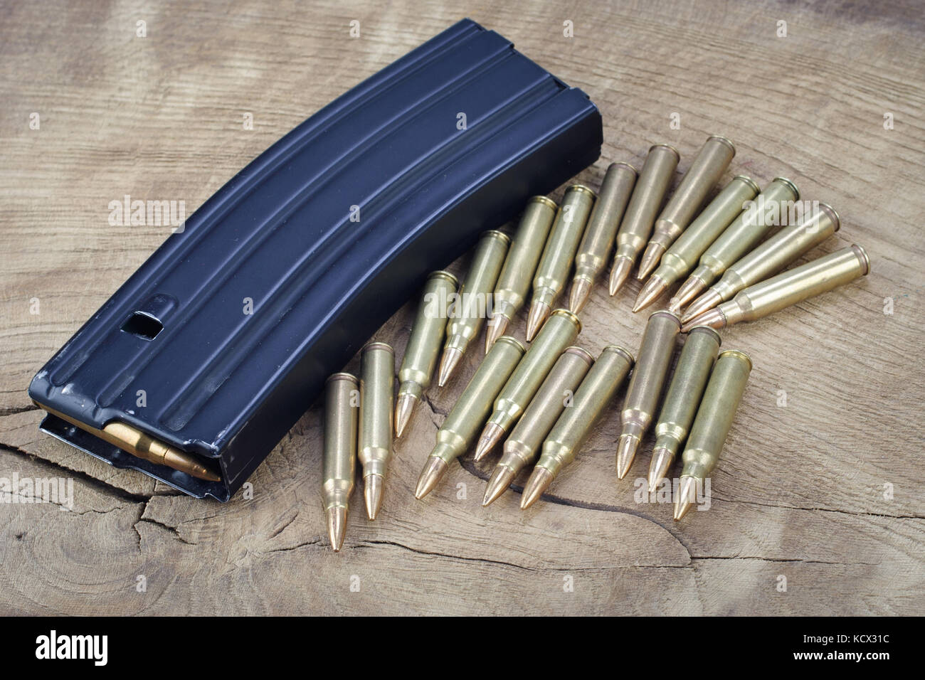 Ammunition with magazine on wooden background Stock Photo - Alamy