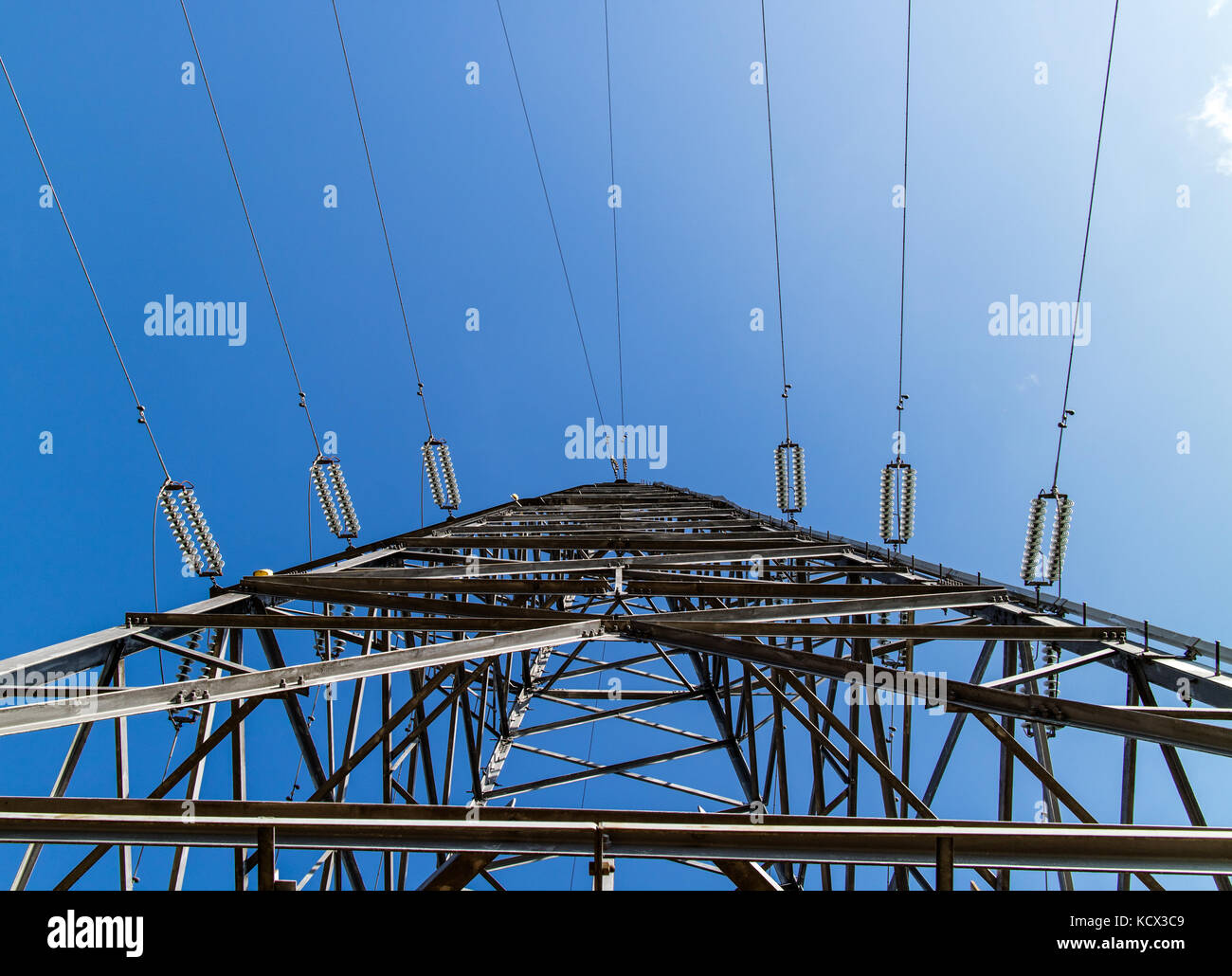 Looking up from the bottom of an electricity pylon, on the background ...