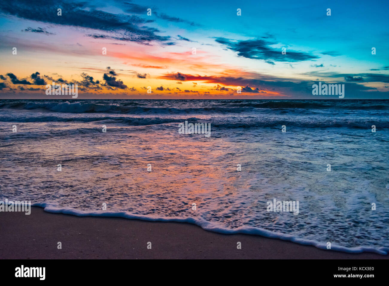 colorful morning at the beach just before sunrise Stock Photo - Alamy