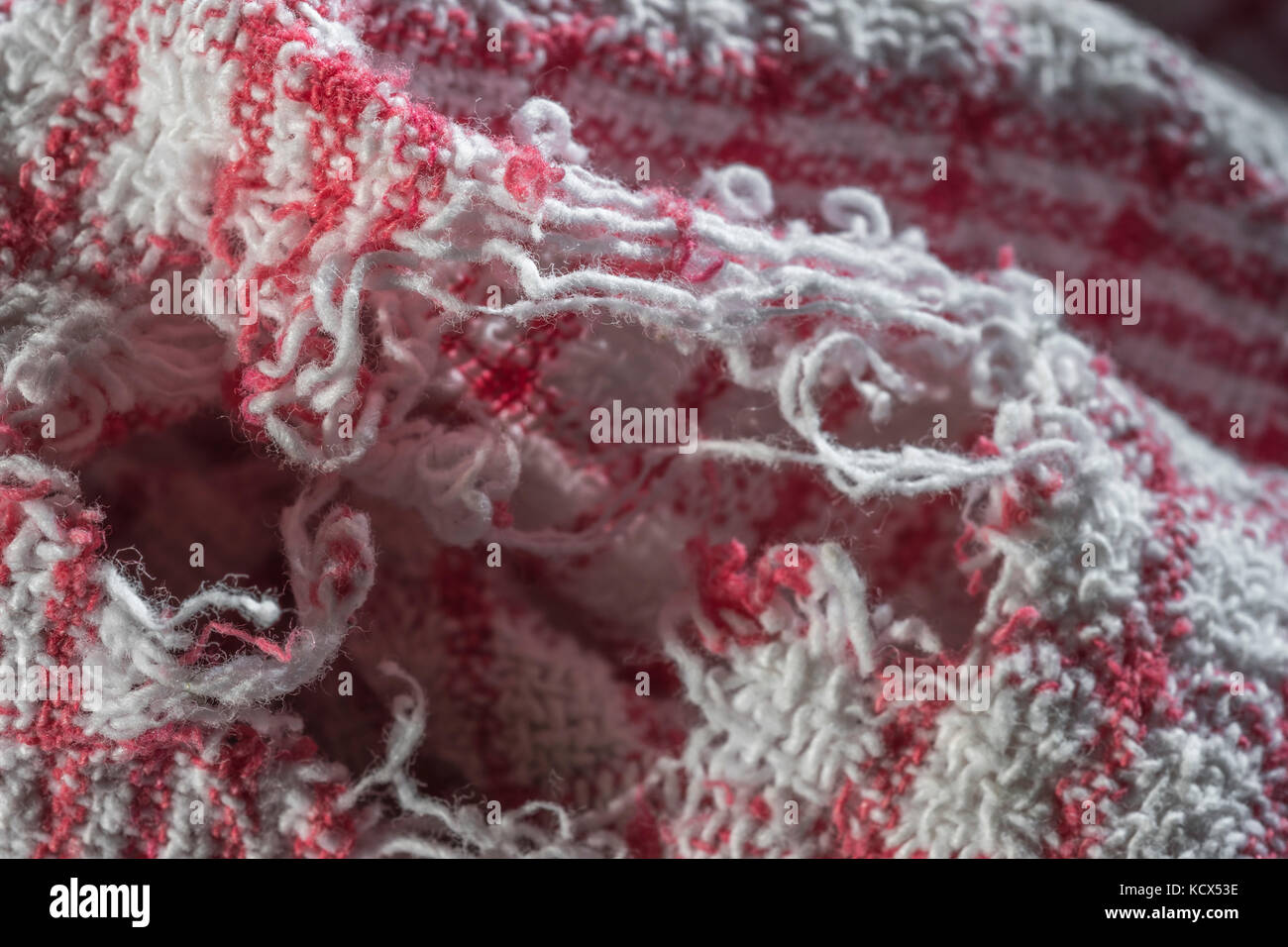 Close-up shot of the frayed edges of an old teacloth. Worn fabric ...
