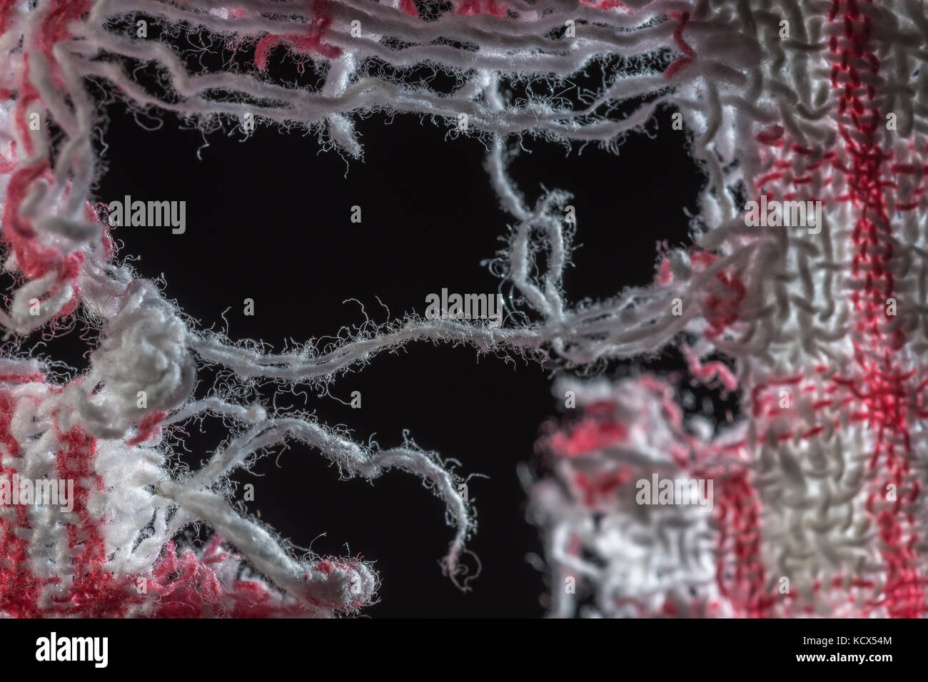 Close-up shot of the frayed edges of an old teacloth. Worn fabric ...