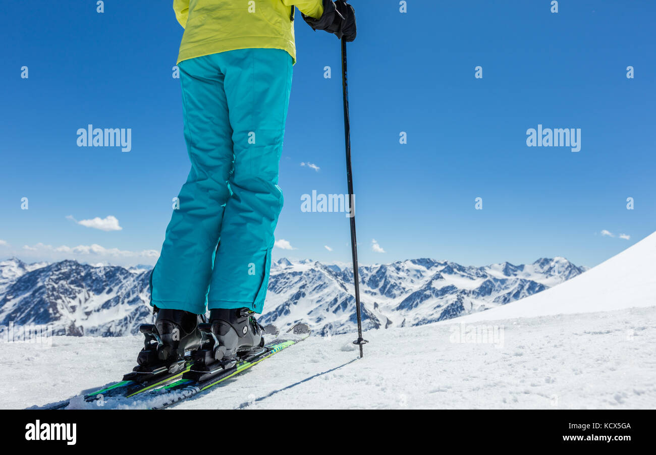 Detail of legs of young woman skier in beautiful Alpine landscape ...
