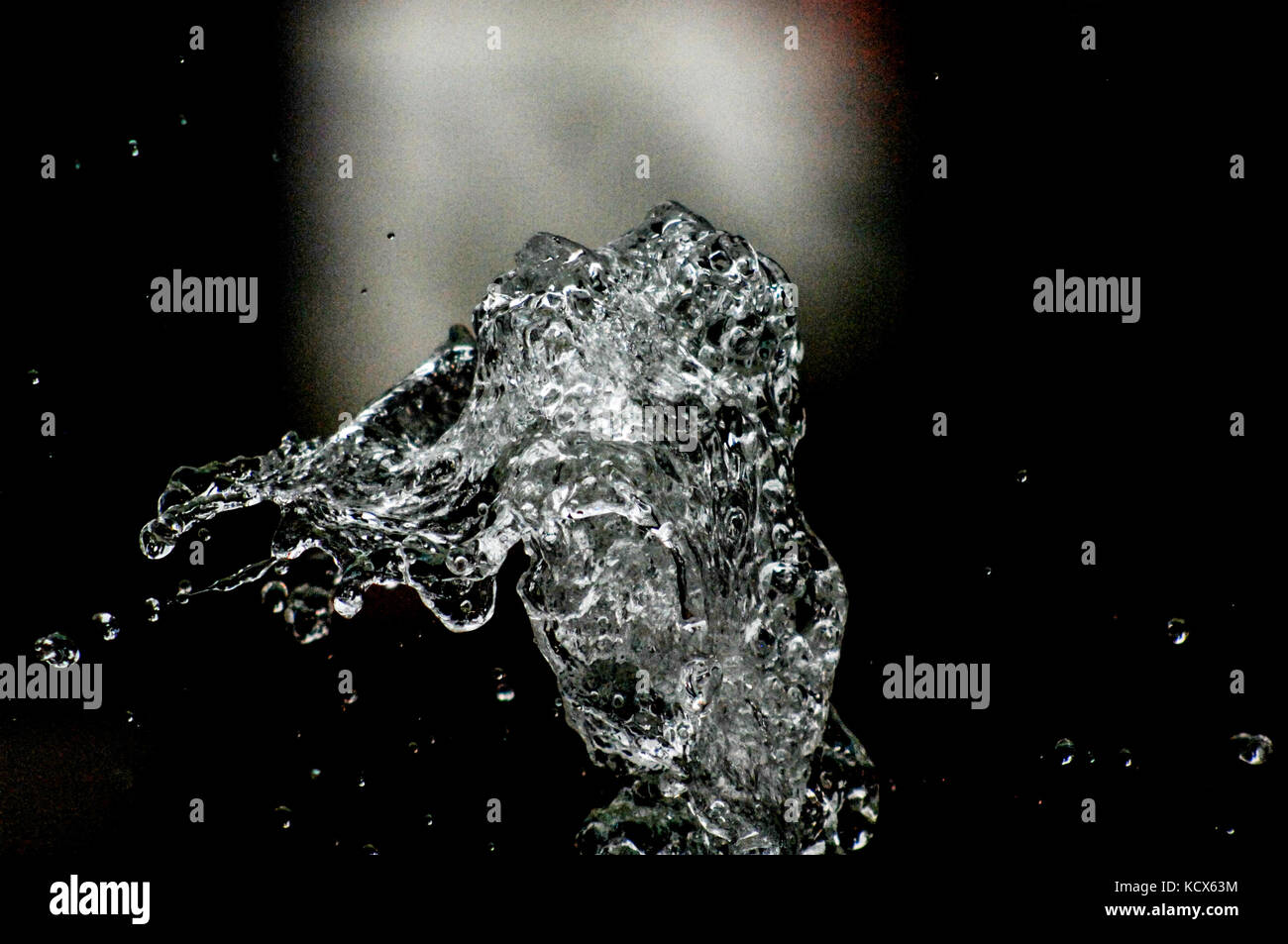 picture of a Water drops levitating in the air in dark. Splashing water ...