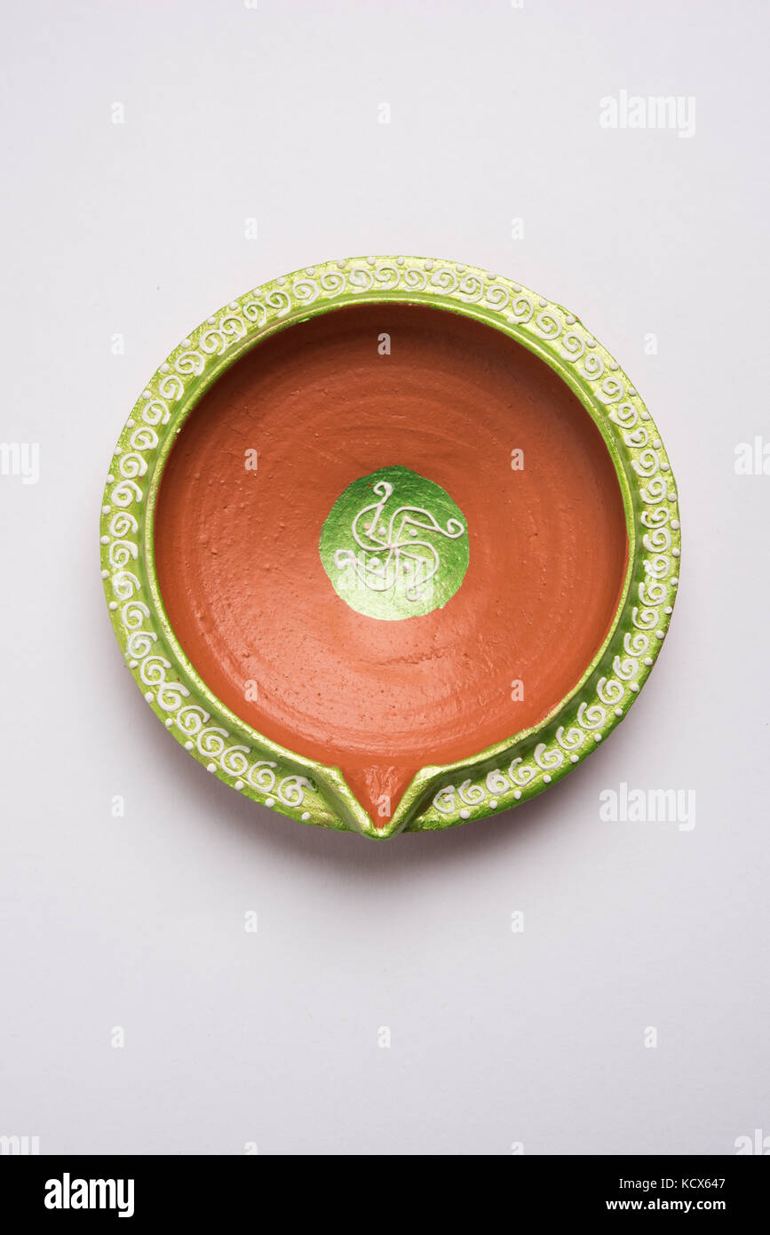 Big and empty designer diwali diya or clay lamp, isolated over white ...