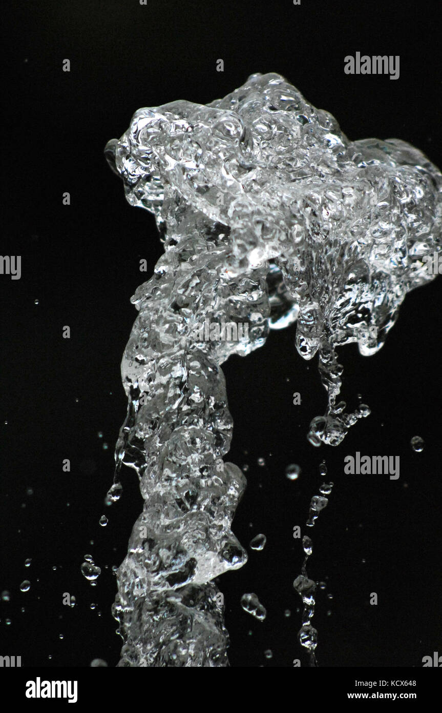 picture of a Water drops levitating in the air in dark. Splashing water ...