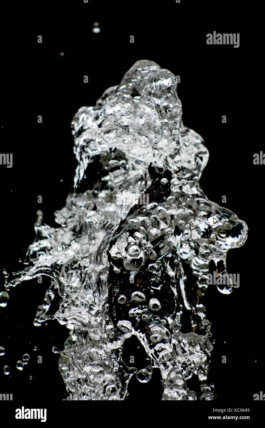 picture of a Water drops levitating in the air in dark. Splashing water ...