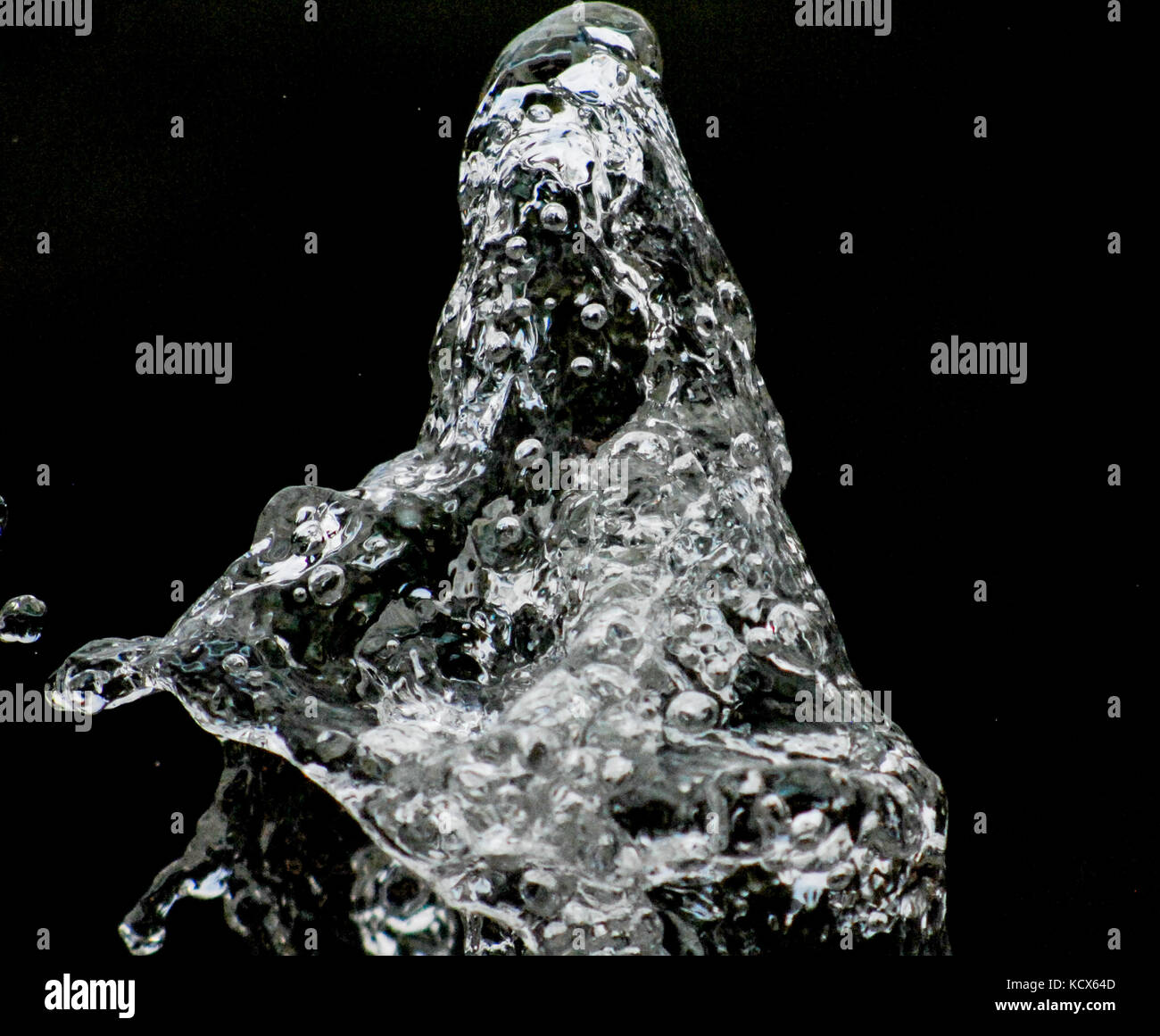 picture of a Water drops levitating in the air in dark. Splashing water ...