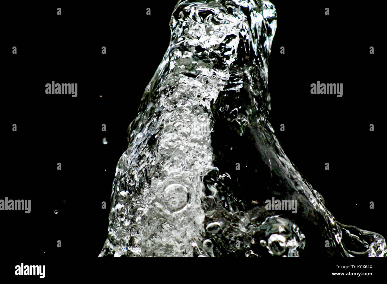 picture of a Water drops levitating in the air in dark. Splashing water ...