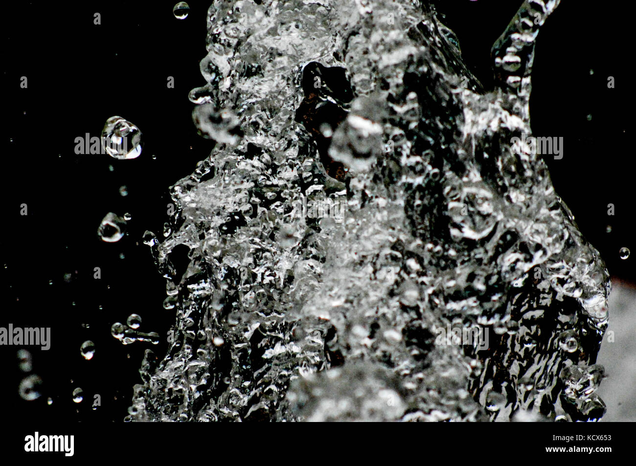 picture of a Water drops levitating in the air in dark. Splashing water ...
