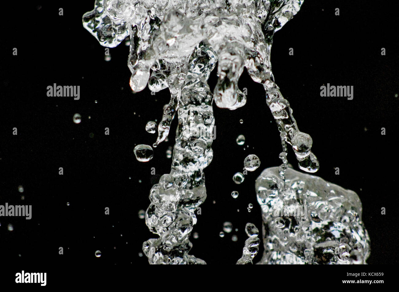 picture of a Water drops levitating in the air in dark. Splashing water ...