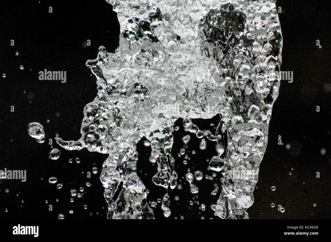 picture of a Water drops levitating in the air in dark. Splashing water ...