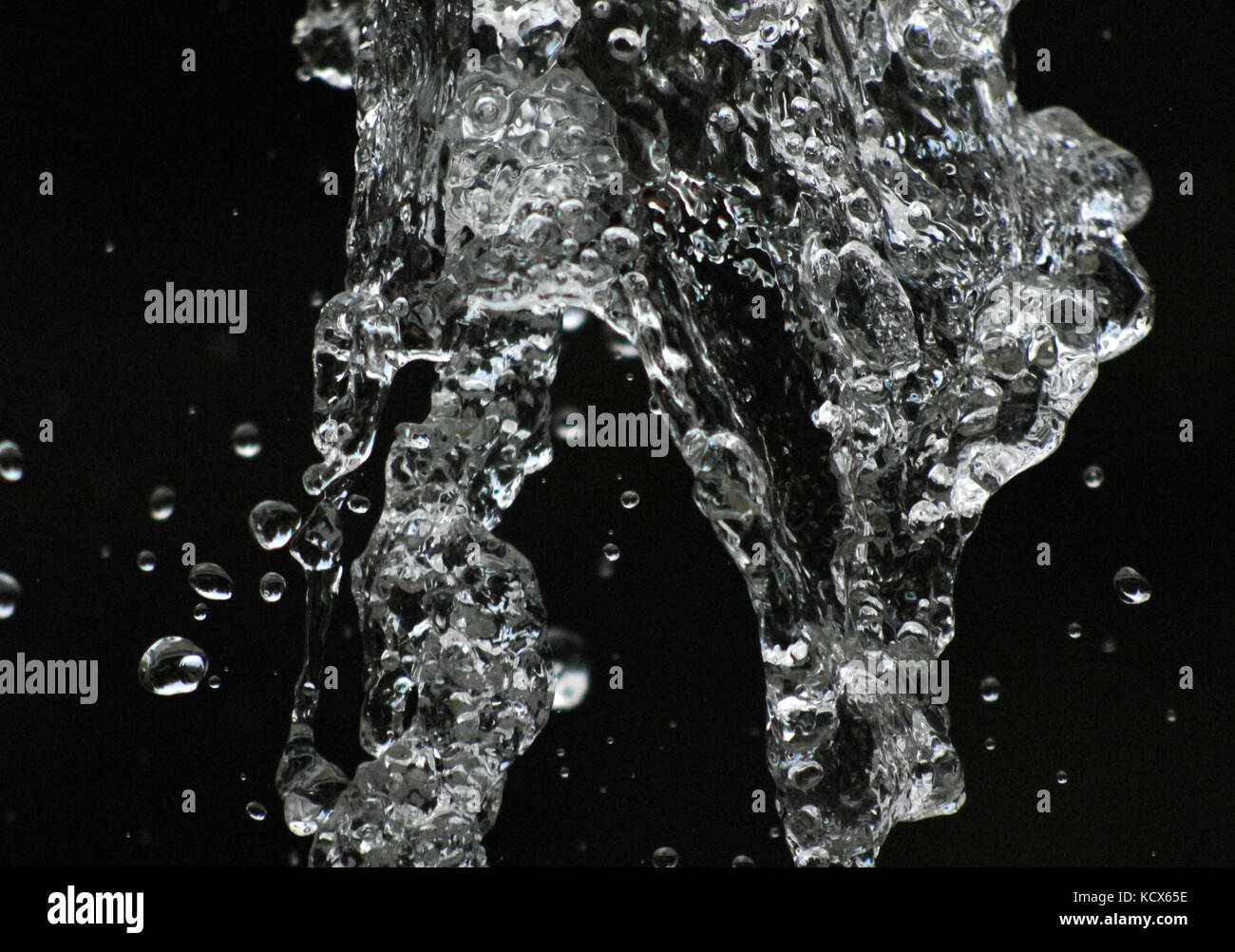 picture of a Water drops levitating in the air in dark. Splashing water ...