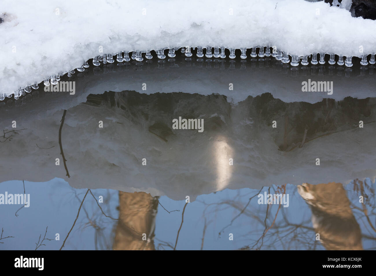 Small round icicles over water Stock Photo - Alamy