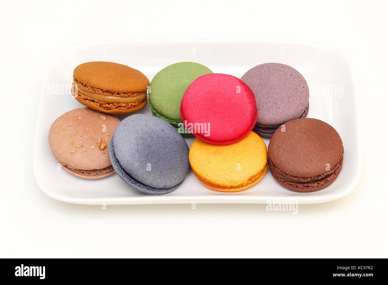 Tasty colorful macaroons pile in ceramic plate Stock Photo - Alamy
