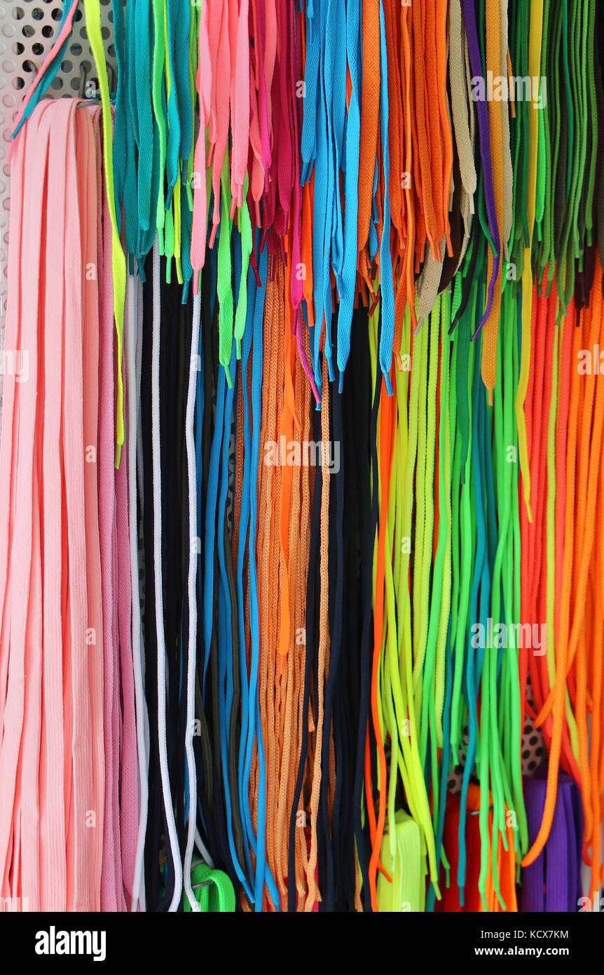 Fashion style colorful shoe laces on wall Stock Photo - Alamy