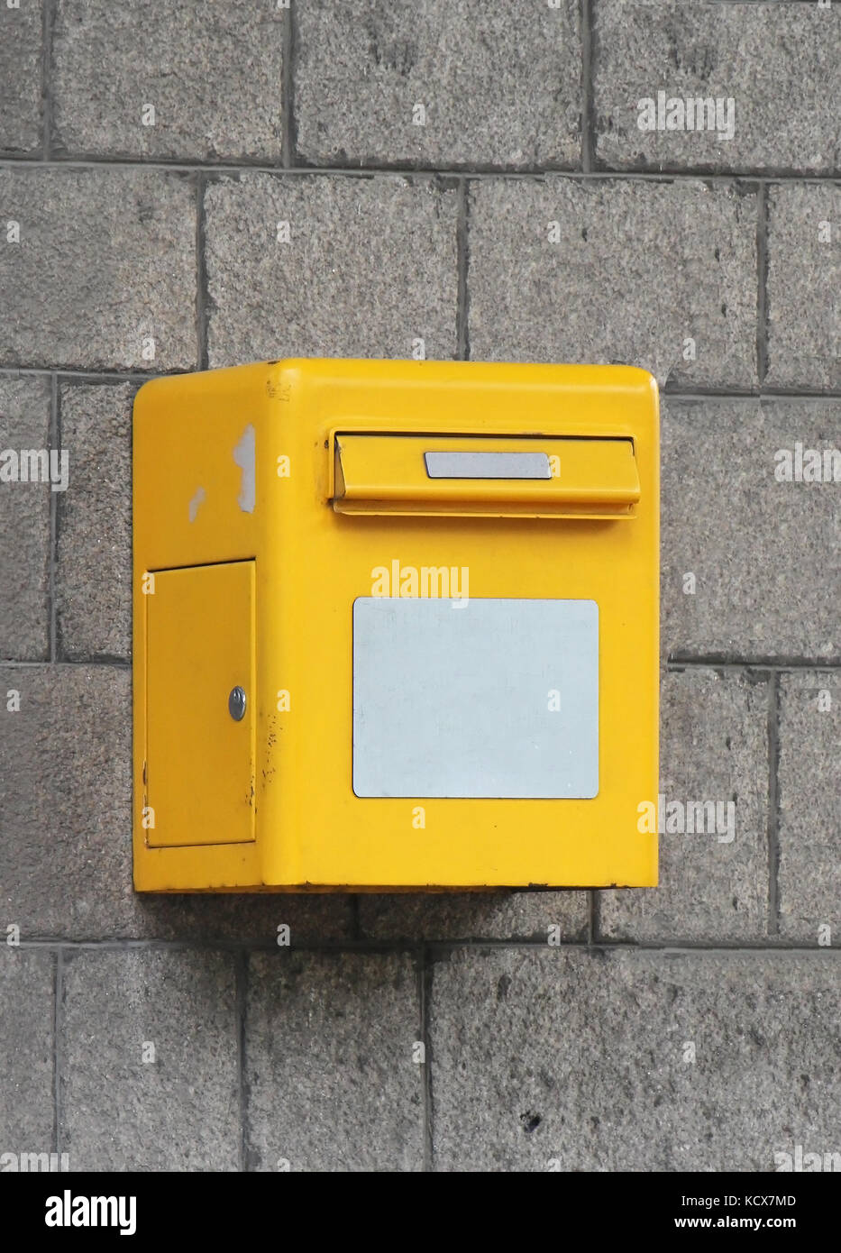 Small yellow post box on building wall outdoor Stock Photo - Alamy