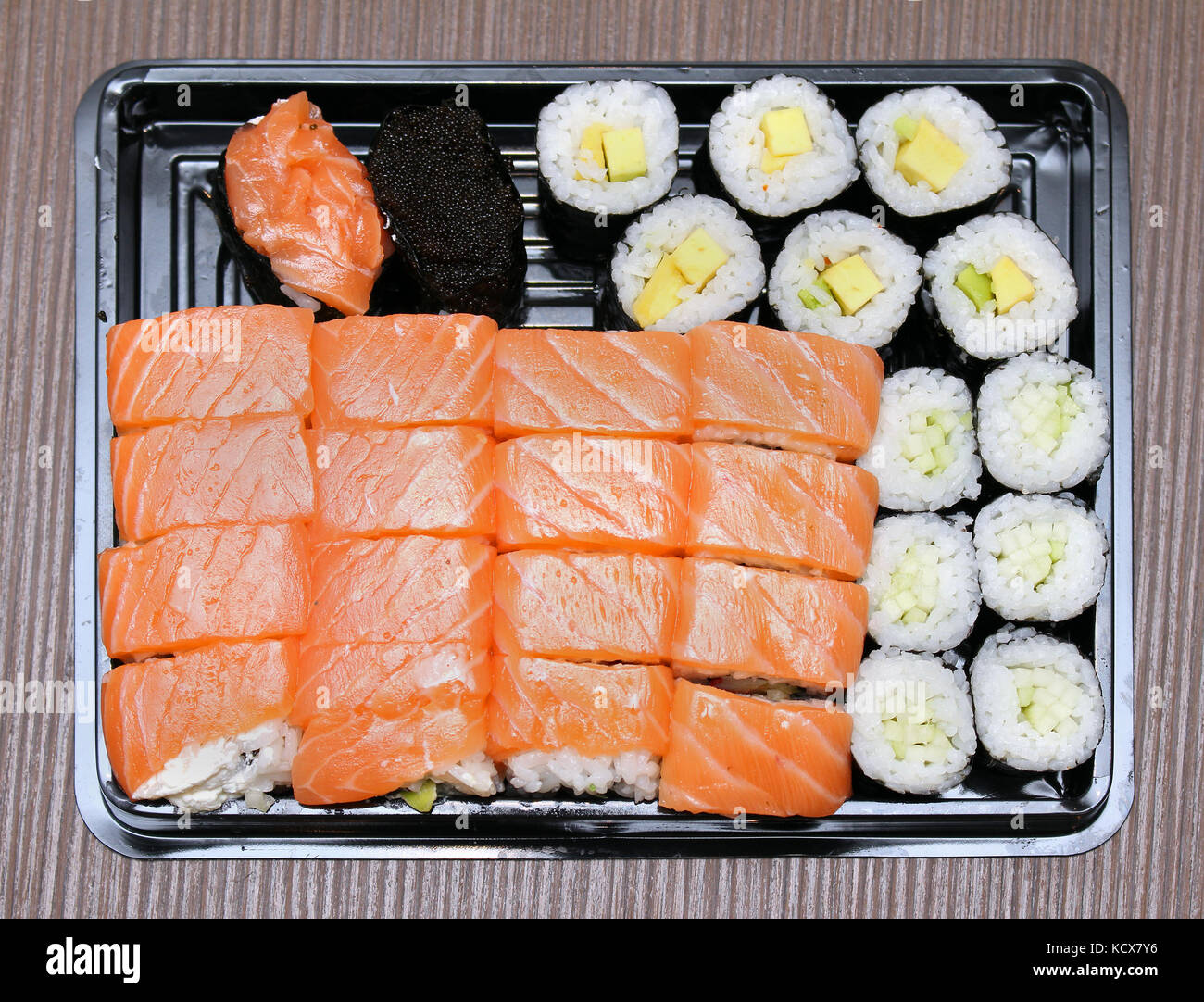 Fresh raw salmon sushi in plastic tray Stock Photo - Alamy