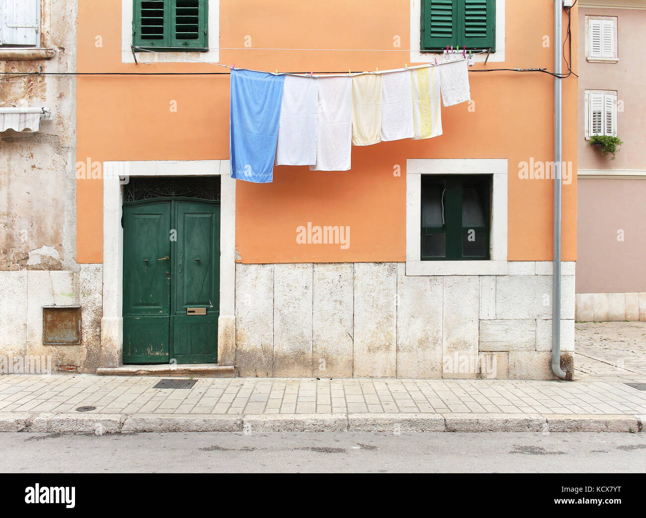 Washed clean laundry drying on clothes line outside the house Stock ...