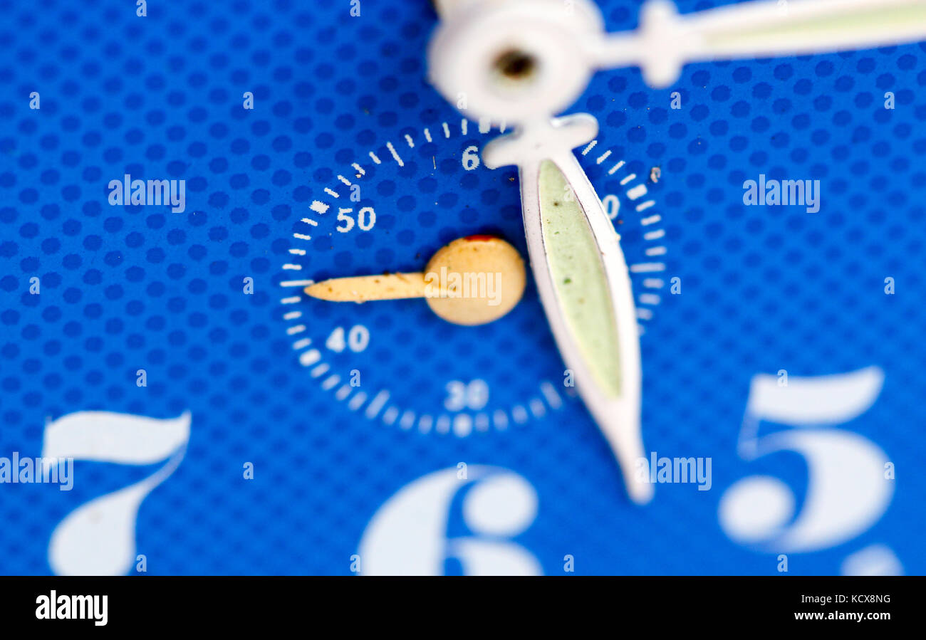 picture of a Closeup of hands on clock face Stock Photo - Alamy