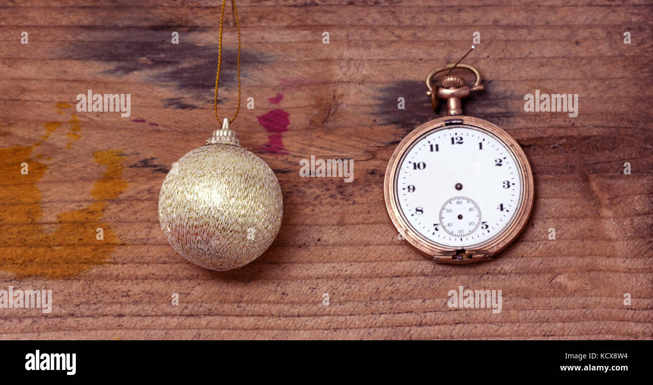 picture , vintage pocket watch and christmas ball on wood background ...