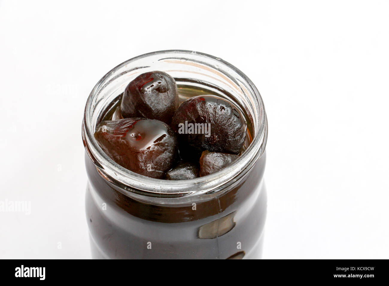 picture of an open jar of preserved figs on white background Stock ...