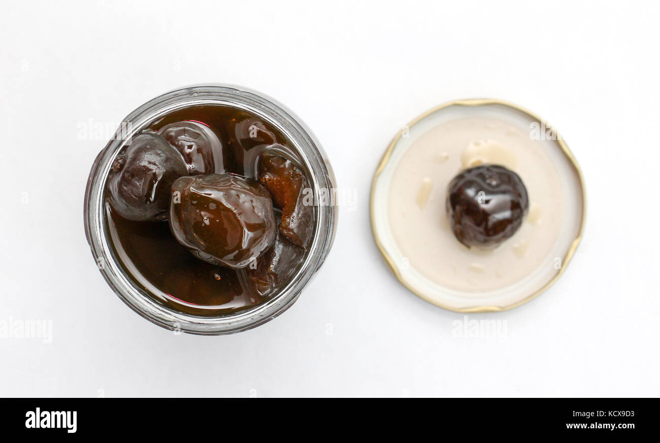 picture of an open jar of preserved figs on white background Stock ...