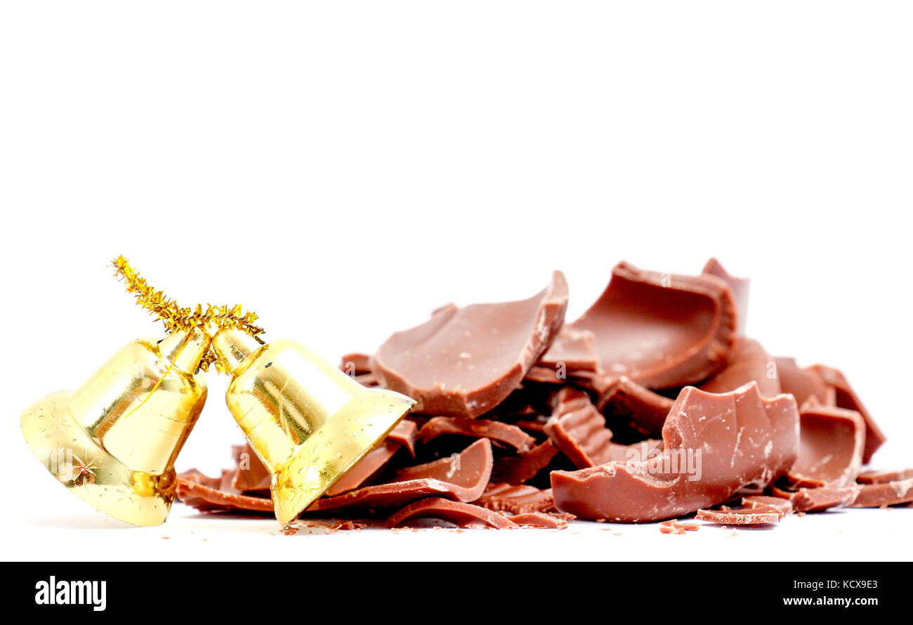 picture of a Chocolate pieces and xmas bells on white background Stock ...