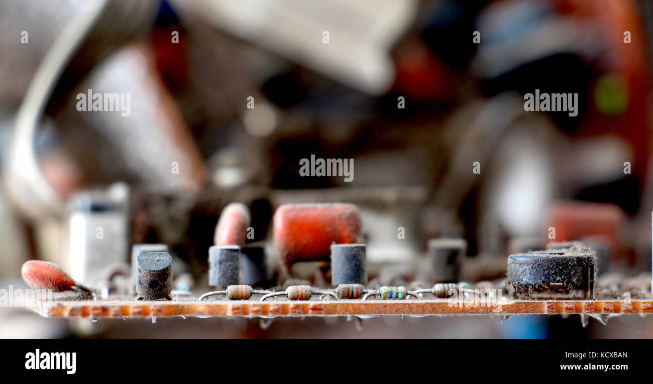 Part of old vintage printed circuit board with electronic components ...