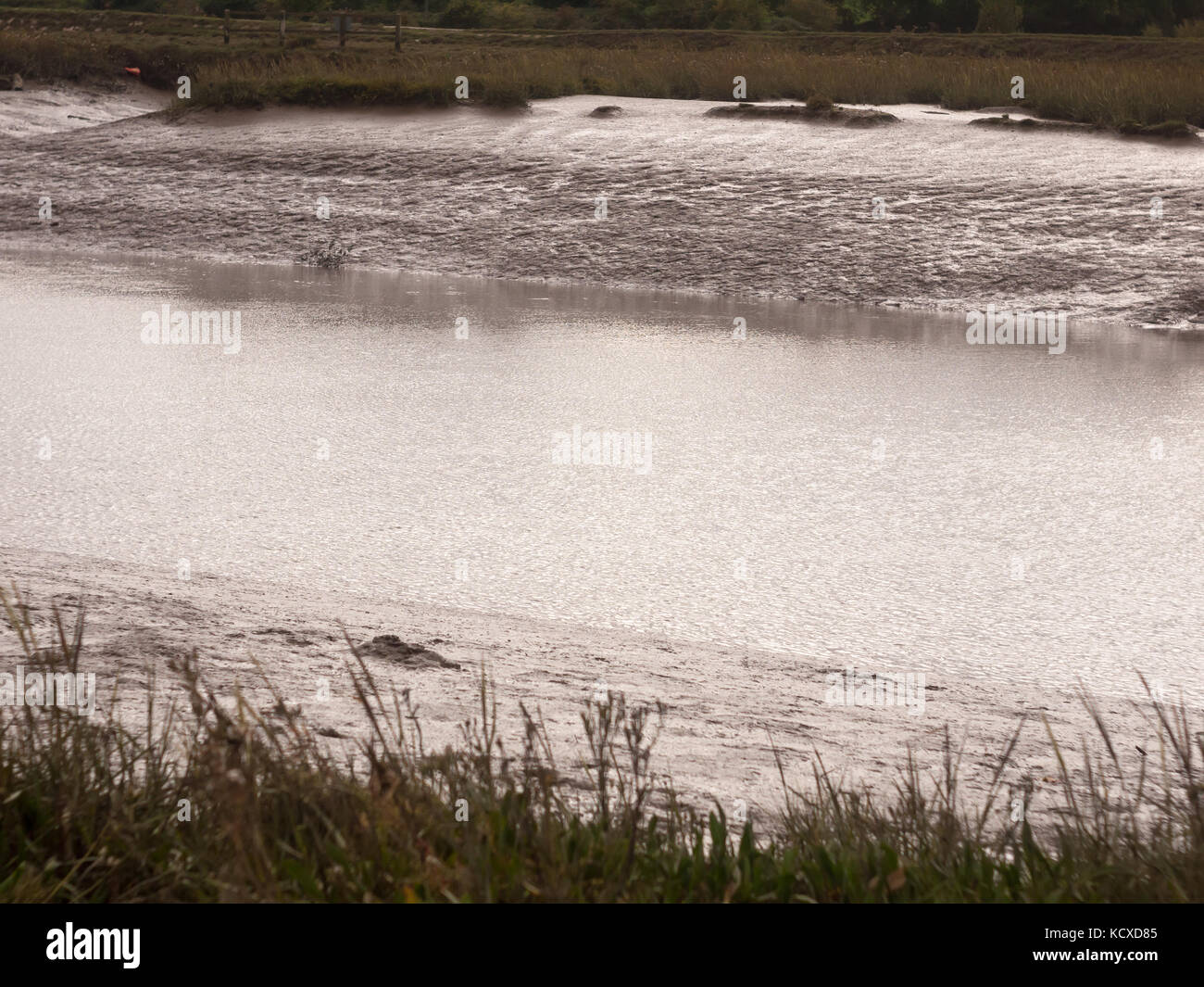 empty grey shallow water channel stream river outside with horizon ...