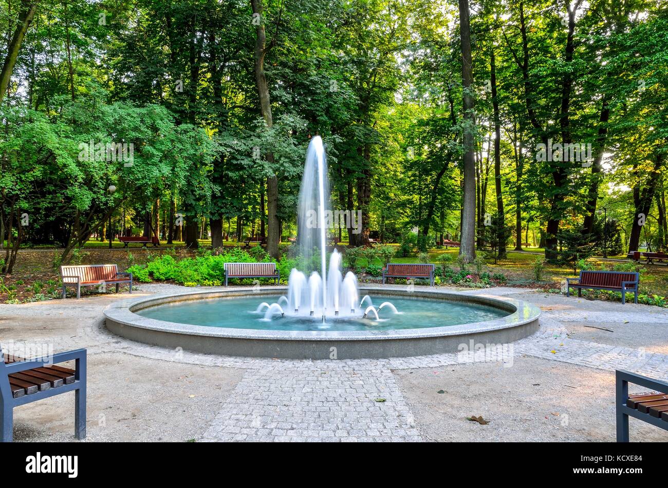 Nice fountain in the urban park. Green park in the city of Chrzanow ...