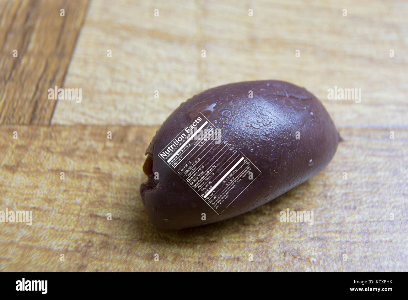 Close up of black olive with nutrition label on wooden board Stock ...