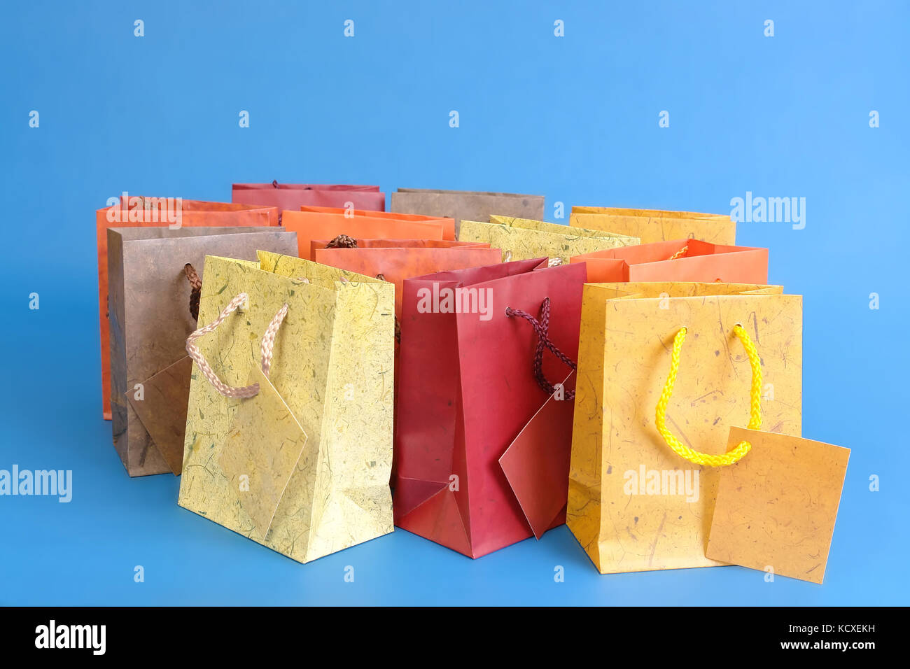 Group of empty colorful paper shopping bags over blue background Stock ...