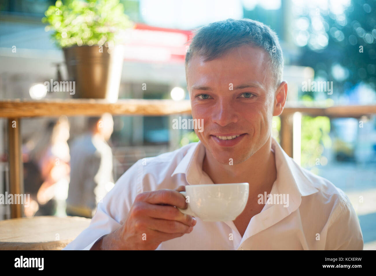 Young man enjoy on coffee break, outdoors portrait Stock Photo - Alamy