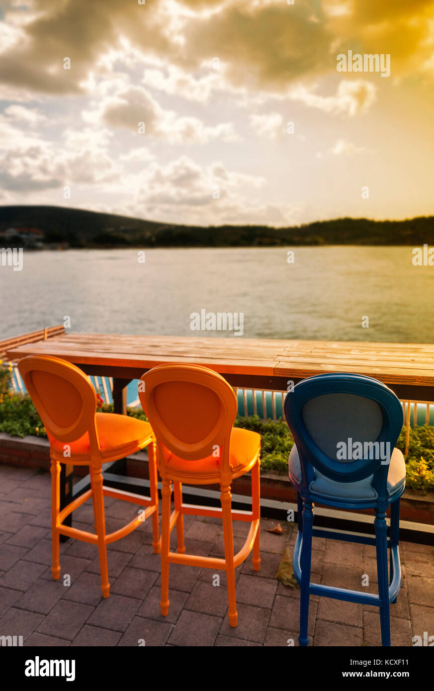 wooden table against sunset and tree chairs Stock Photo - Alamy