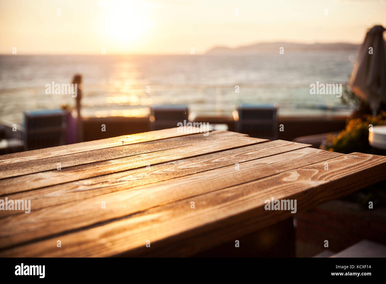 wooden table against sunset on sea, close up Stock Photo - Alamy