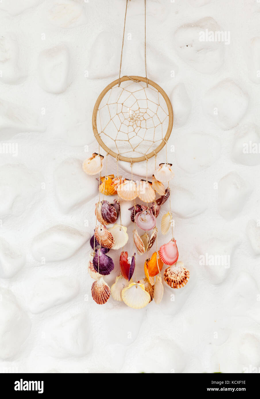 trap for dreams with decorative shells on white stone wall Stock Photo ...