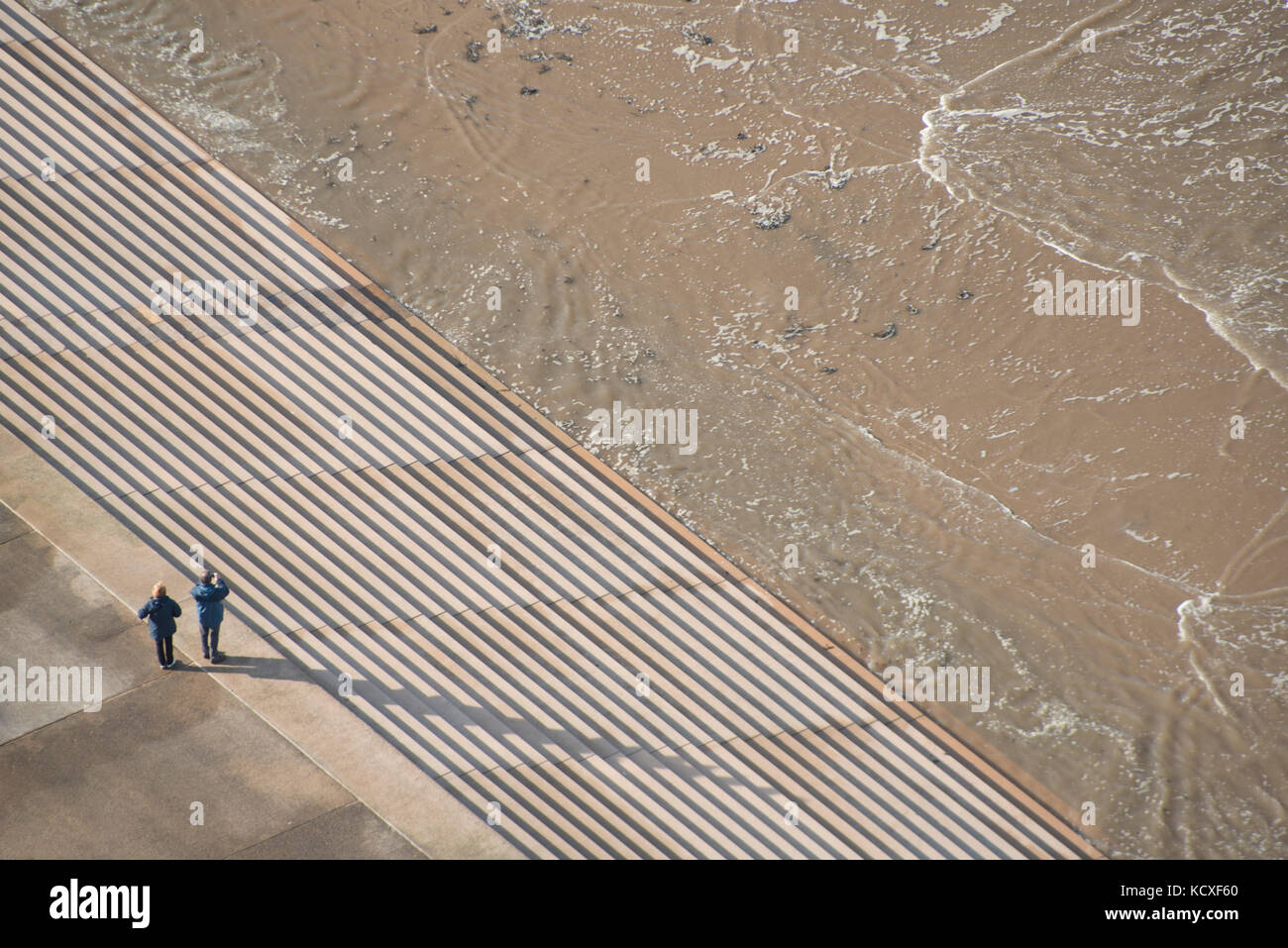 A couple on looking out to sea, on Blackpool beach Stock Photo - Alamy