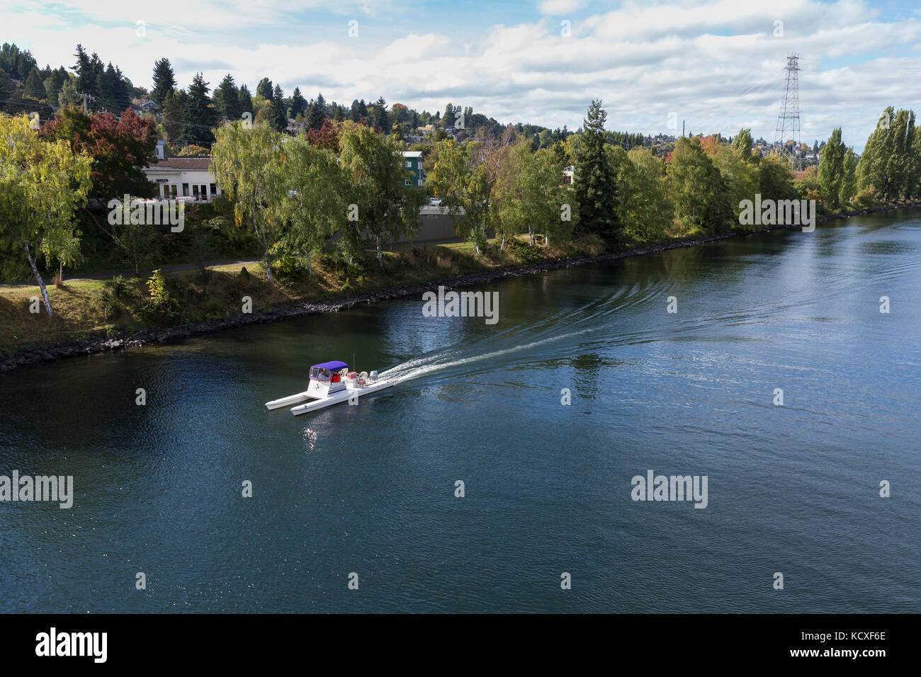 Seattle, Washington: University of Washington coach boat sailing along ...