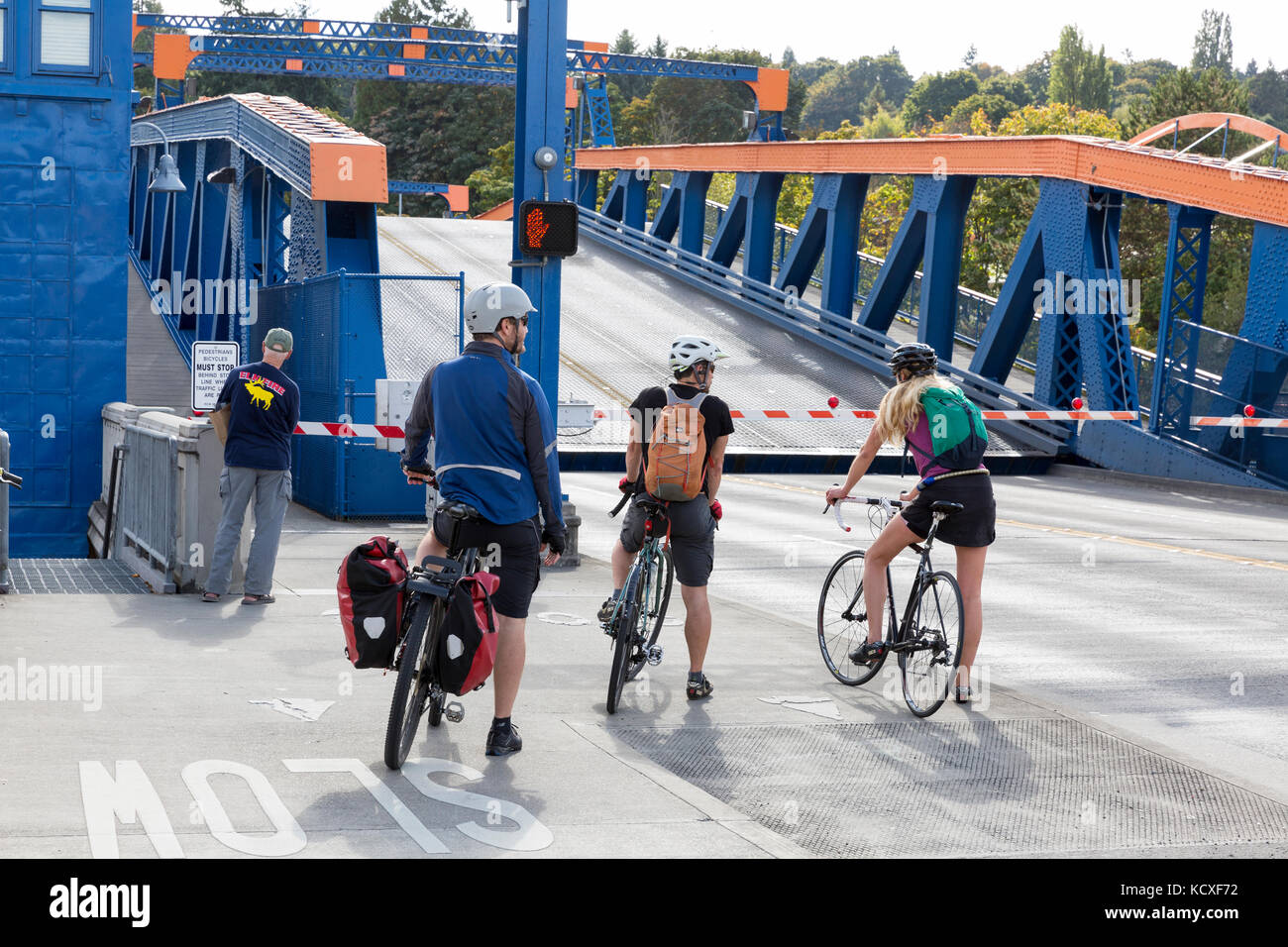 Seattle, Washington: Cyclists and pedestrians wait as the Fremont ...