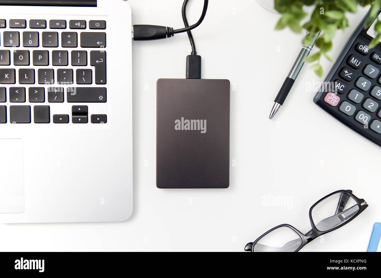 External backup disk hard drive connected to laptop. hard drive backup ...