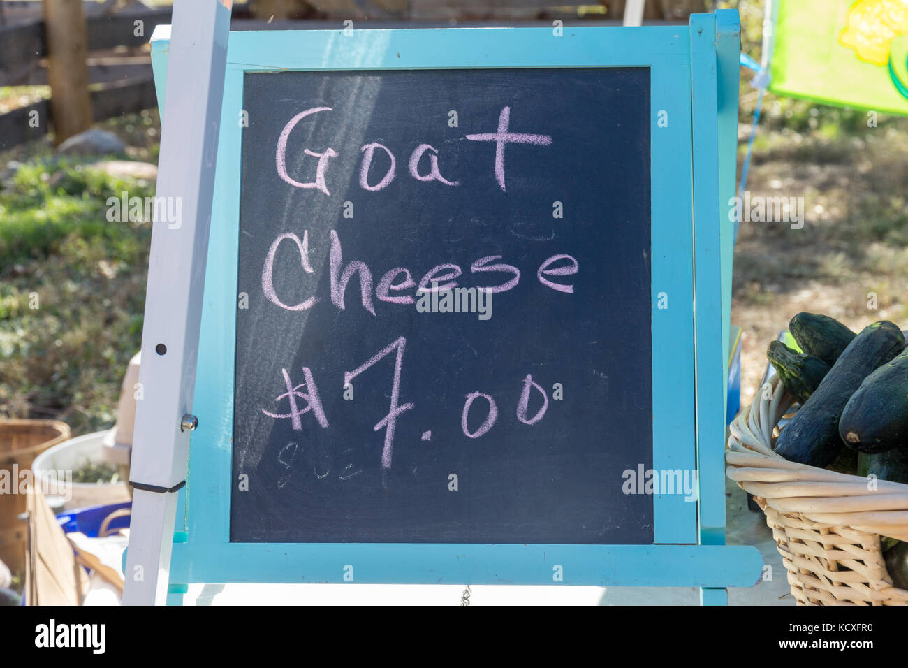 Hand written chalk sign advertising Goat Cheese for sale at a farmers ...