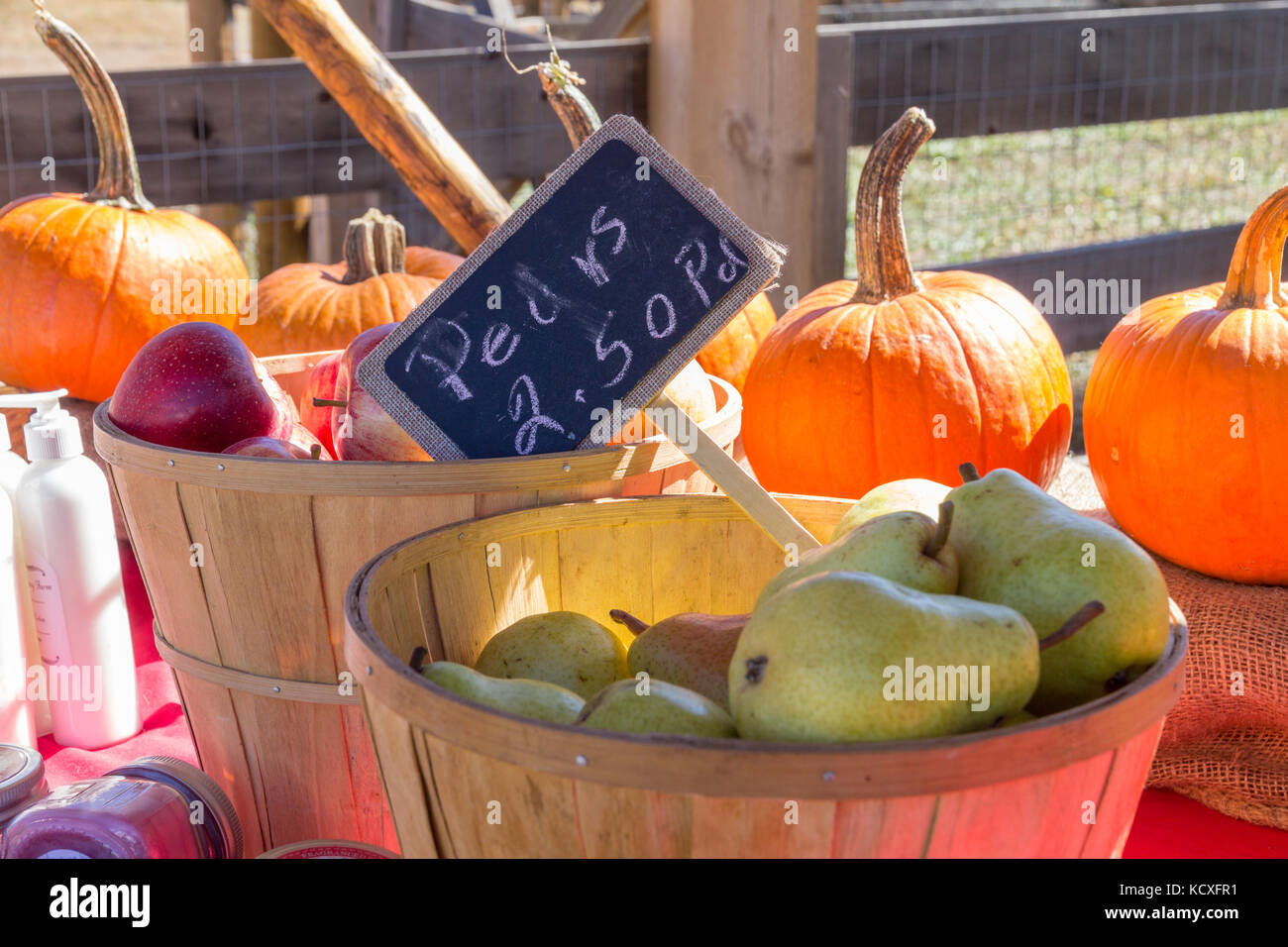 Sign advertising pears for sale with a basket of pears, apples and ...